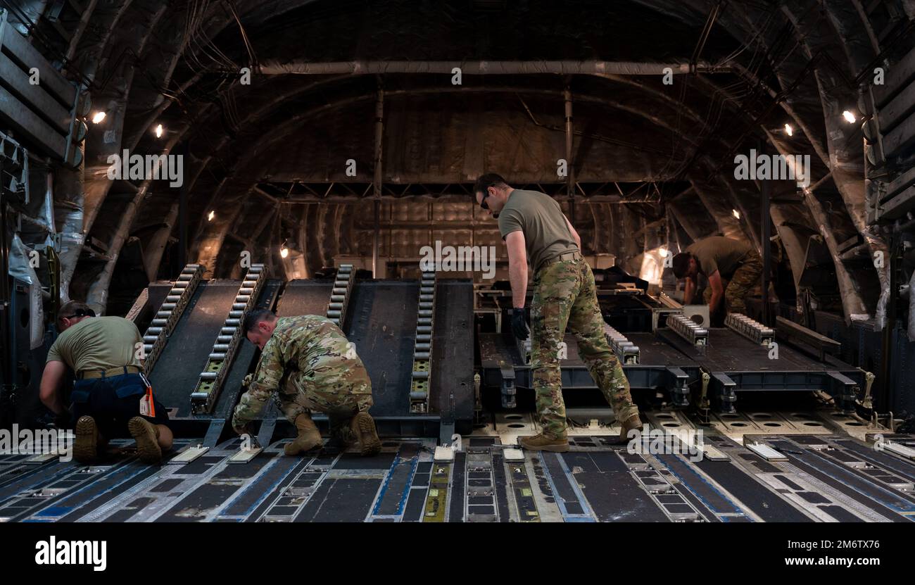 U.S. Airmen configure the ramp toes of a C-17 Globemaster III to ...