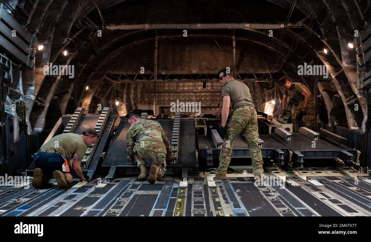 U.S. Airmen configure the ramp toes of a C-17 Globemaster III to ...