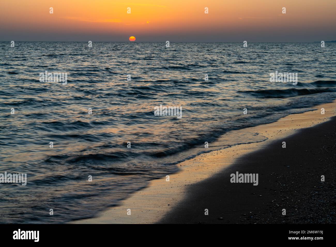 Colorful sunset on the Mediterranean Sea in Greece with calm ocean ...