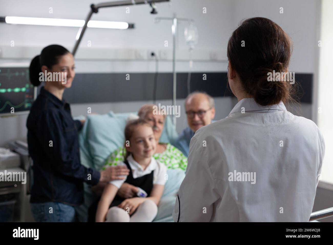 Nurse practitioner visiting happy elderly patient room in recovery ...