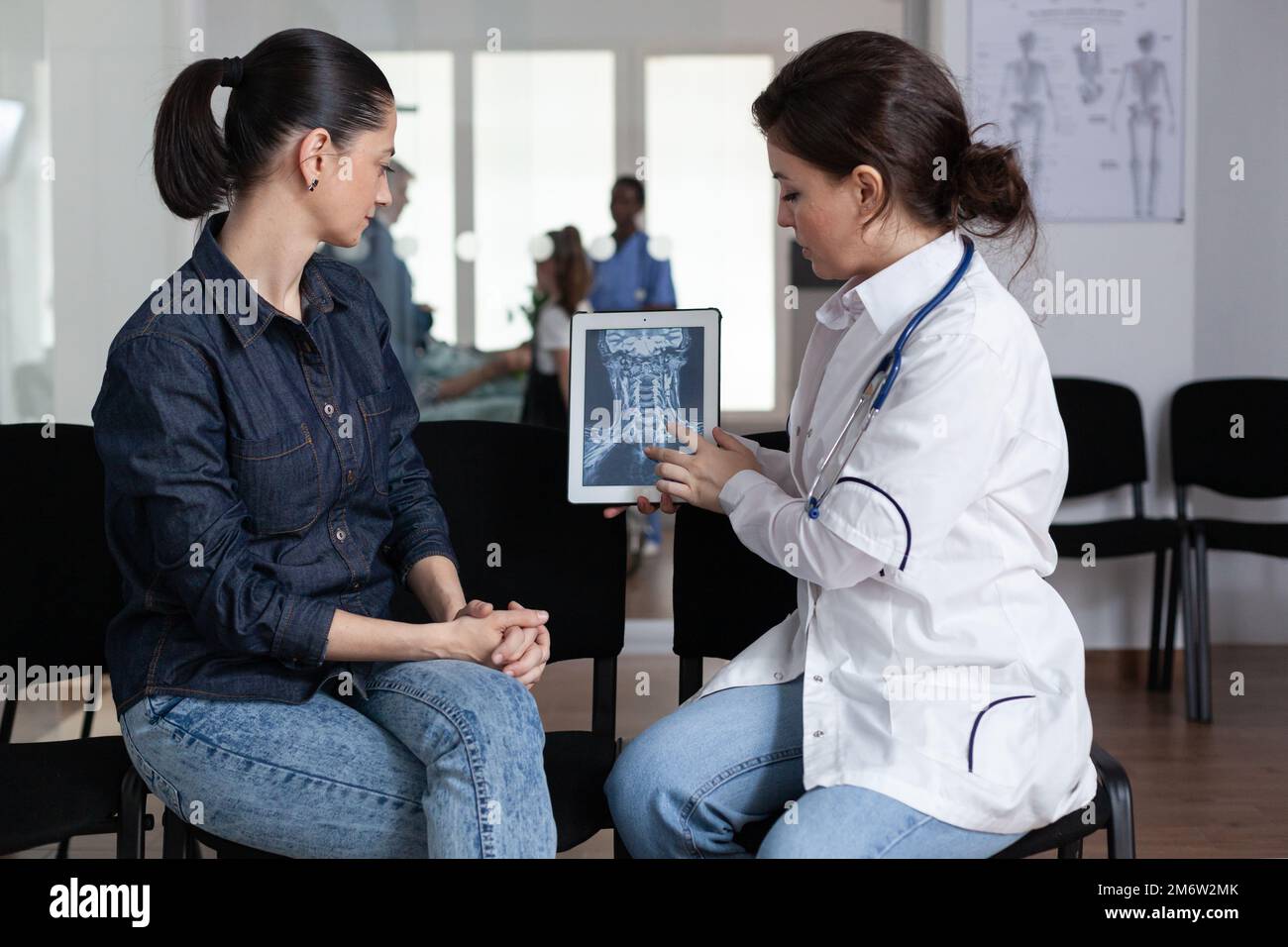 Female medical specialist interpreting digital x ray in hospital ...