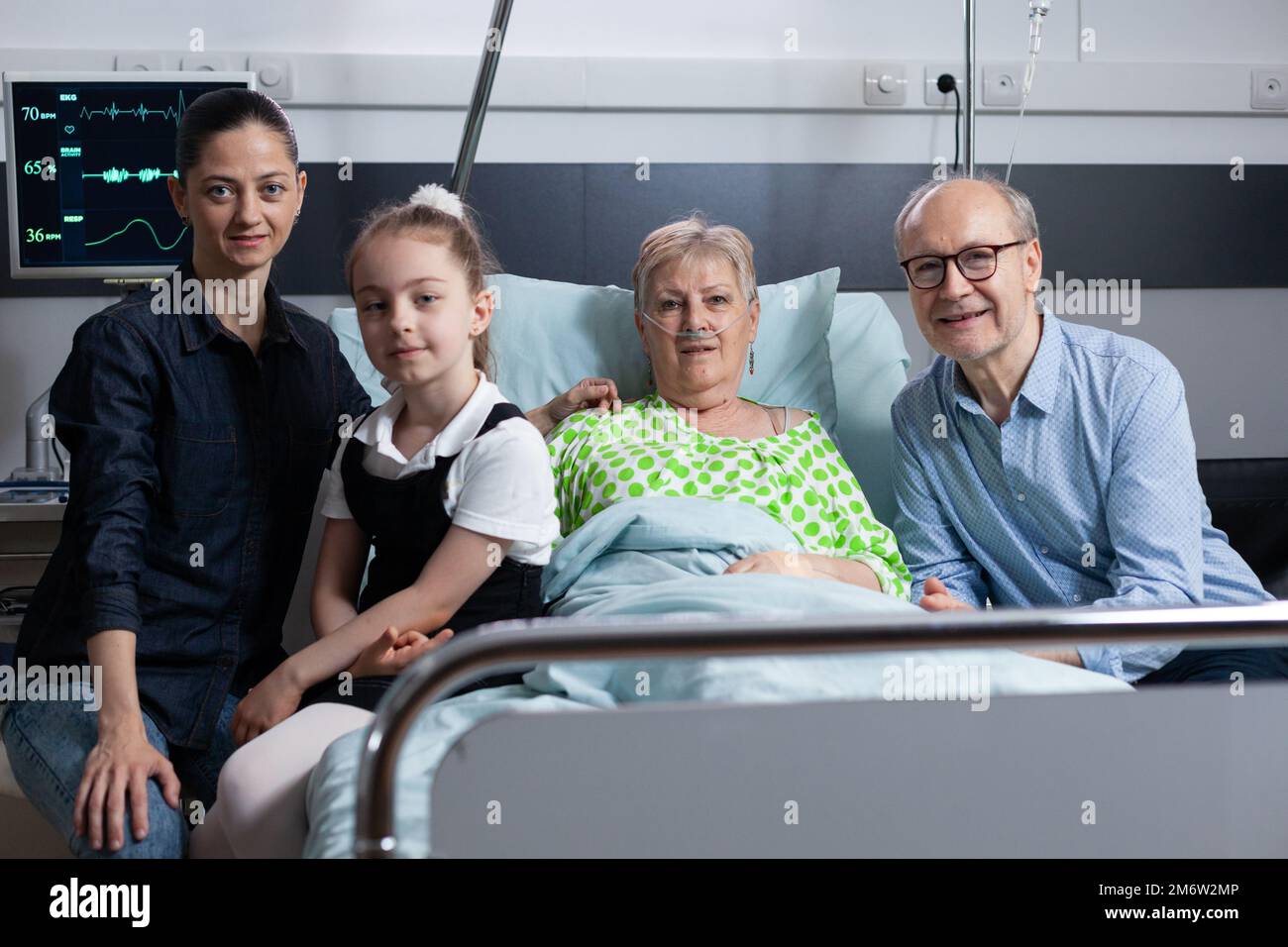 Doctor smiling senior patient during medical procedure hi-res stock ...