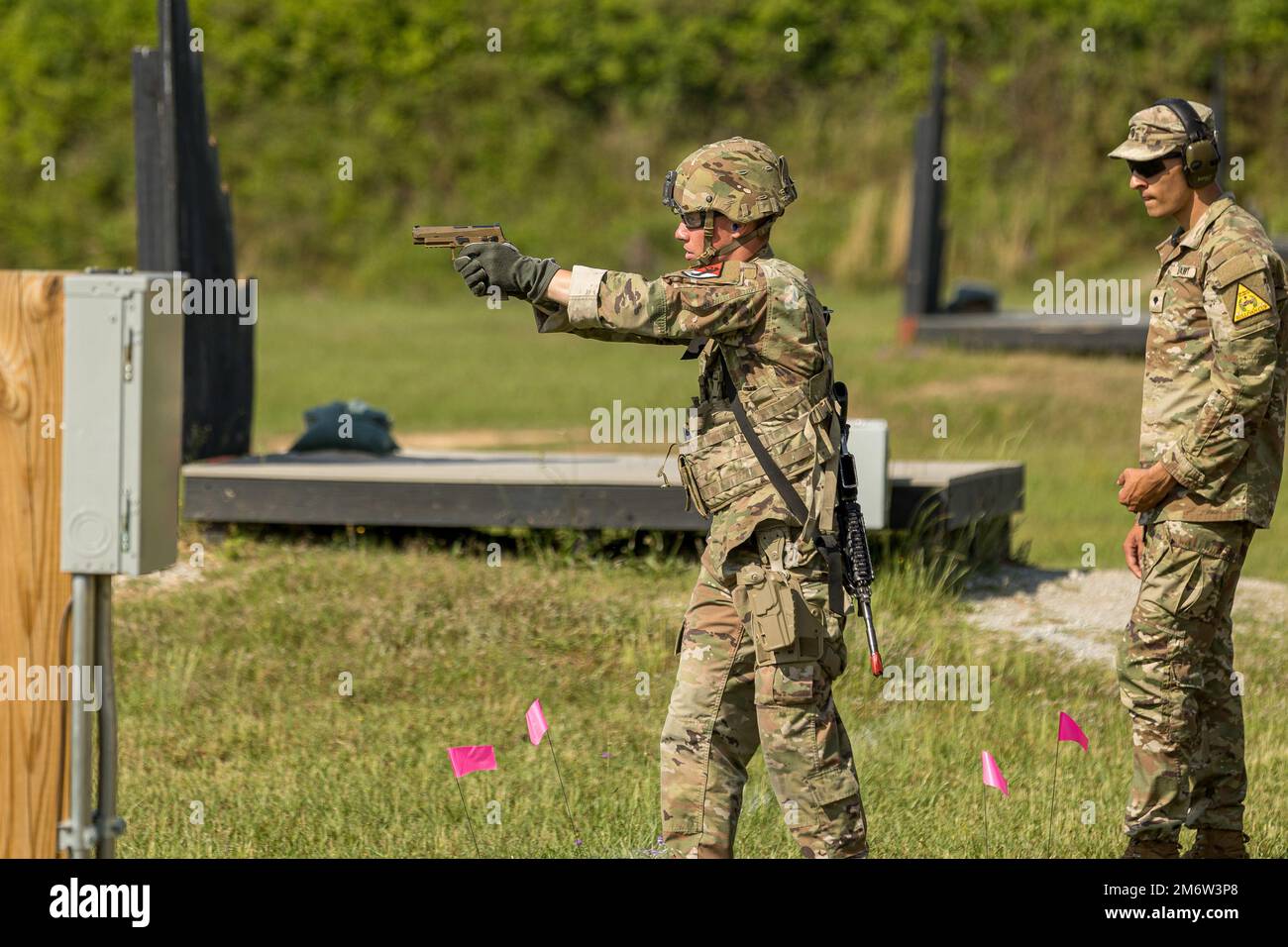 Spc. Joshua Kramer fires his M17 pistol during the stress shoot event ...