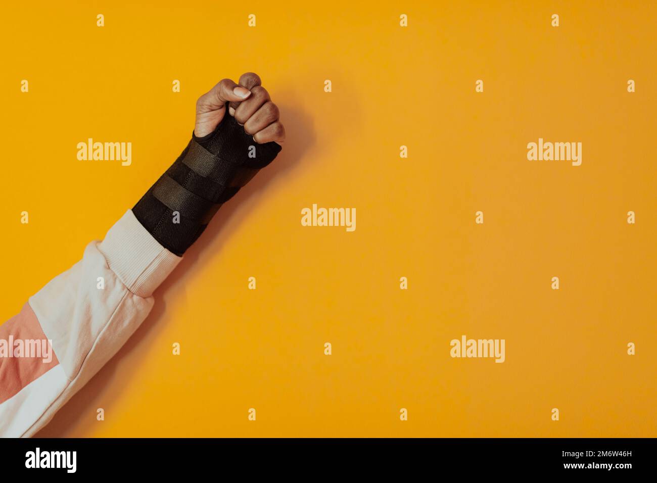 Isolated hurt hand of afro girl on yellow background Stock Photo - Alamy