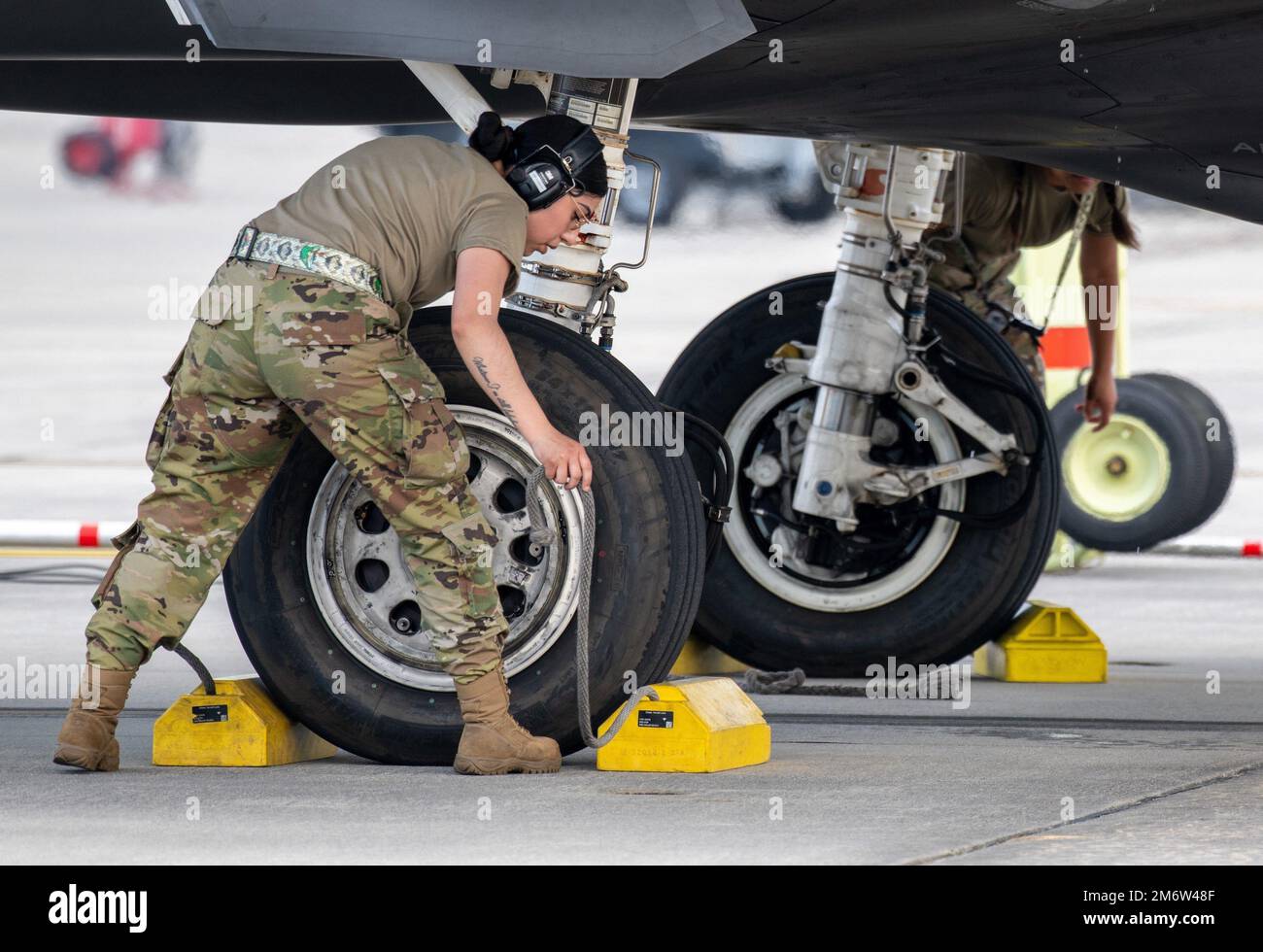 A reservist from the 419th Fighter Wing places chocks on an F-35A ...