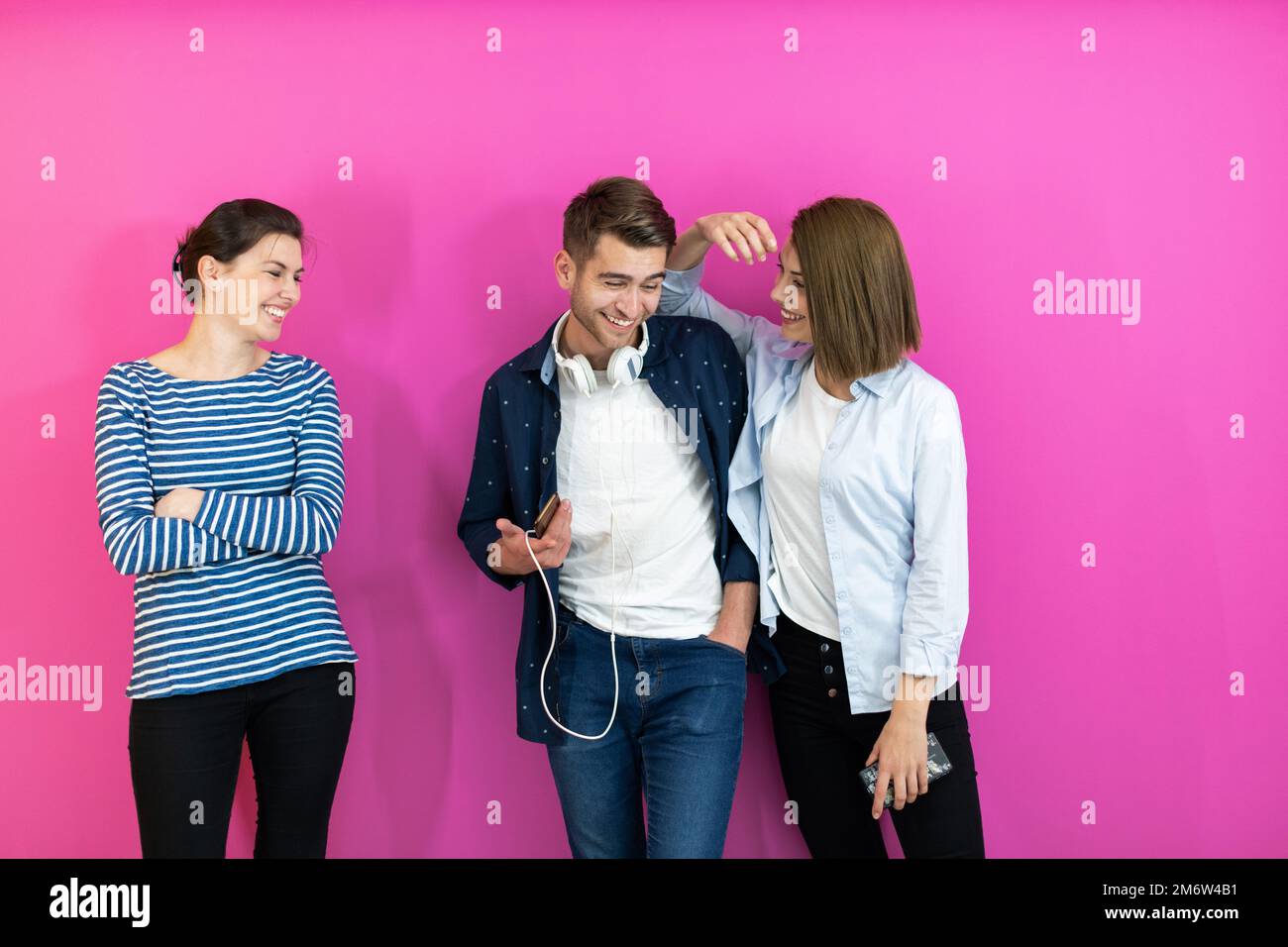 Group of young people in modern clothes posing and having fun isolated ...
