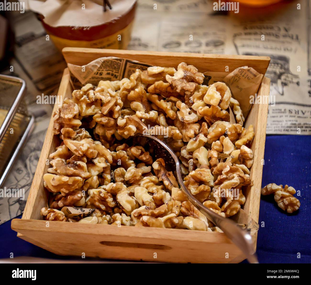 Lots of walnut kernels in a wooden box on a buffet Stock Photo - Alamy