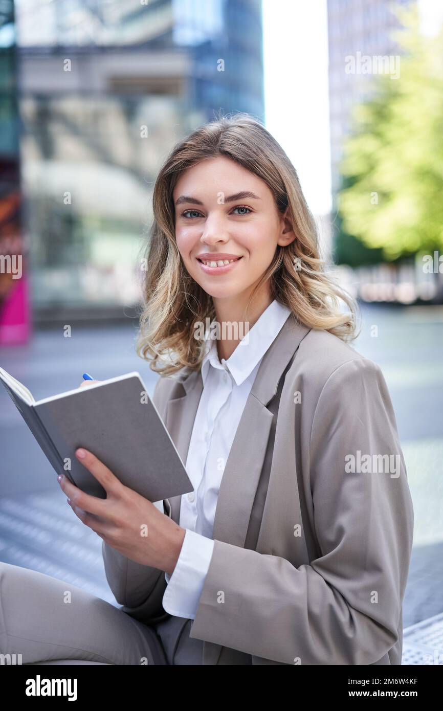 Young woman sits outside works hi-res stock photography and images - Alamy