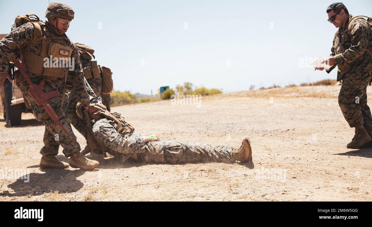 A U.S. Navy Hospital Corpsman with 1st Marine Division drags his ...