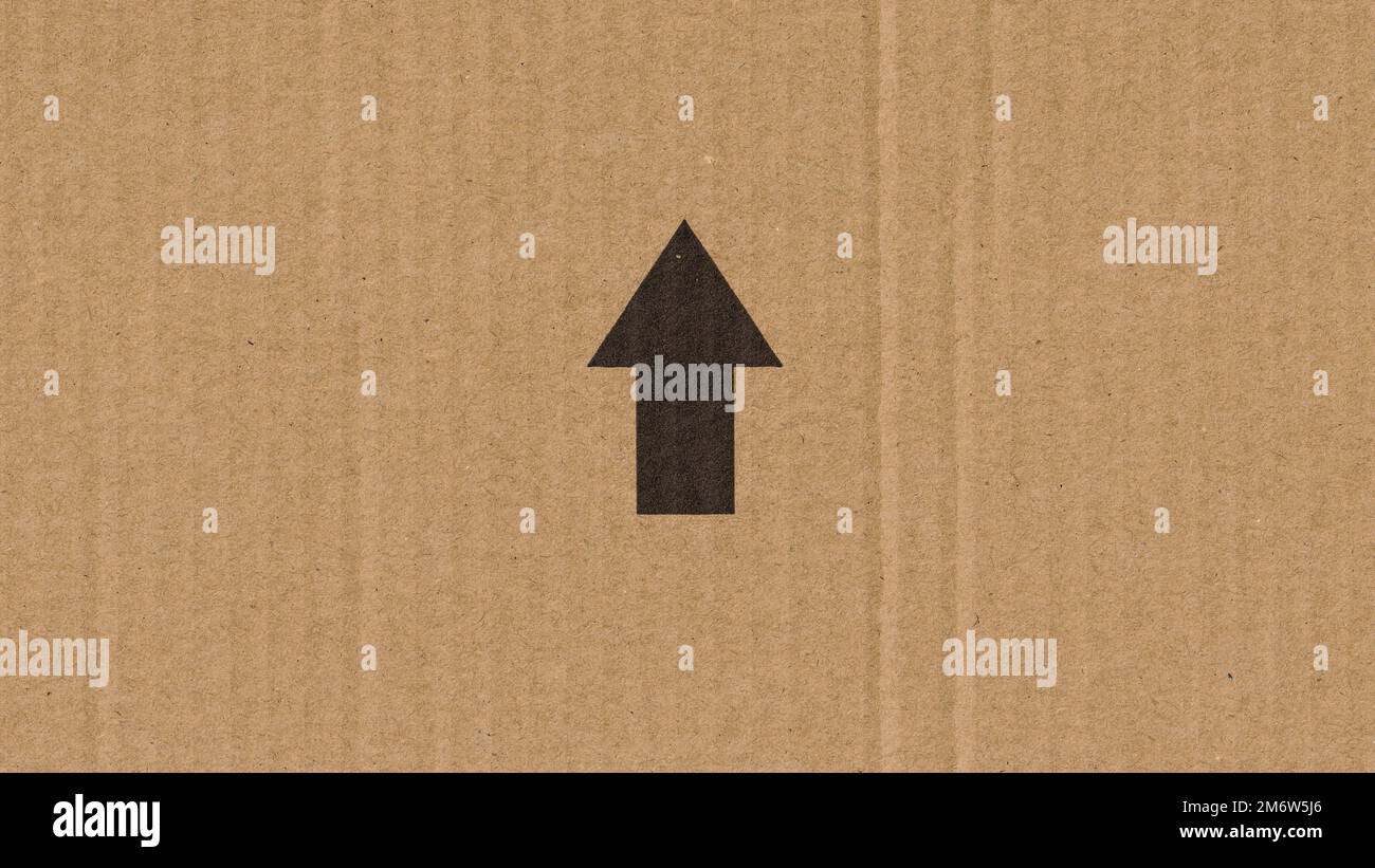 Black arrow on a cardboard box Stock Photo - Alamy