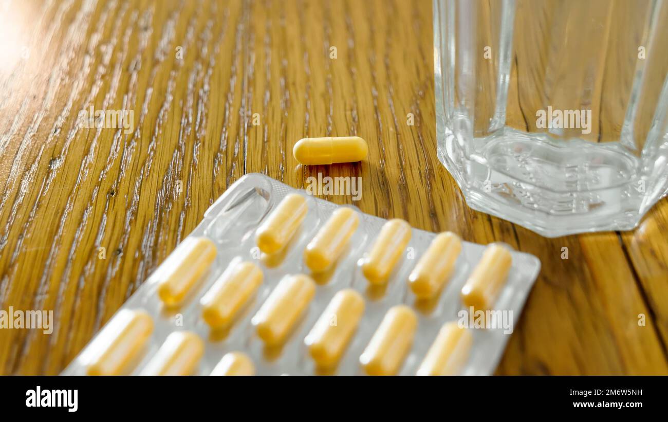 Yellow pills in a blister pack Stock Photo - Alamy