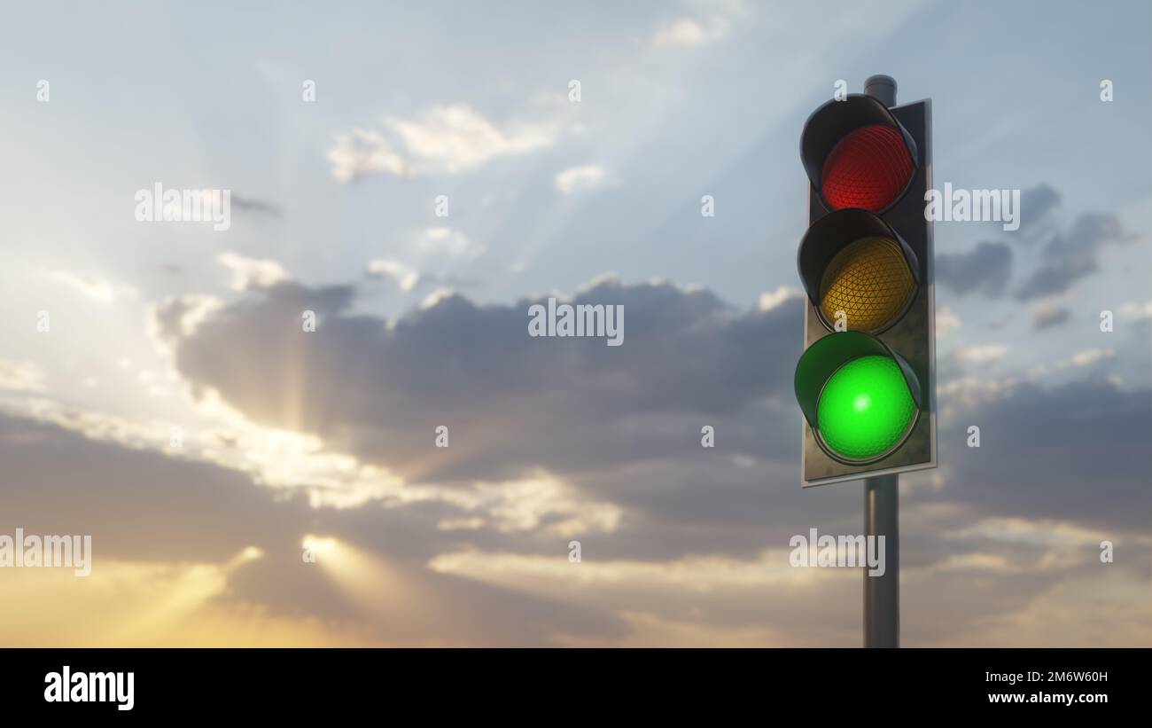 Traffic light shows green with sunset Stock Photo - Alamy