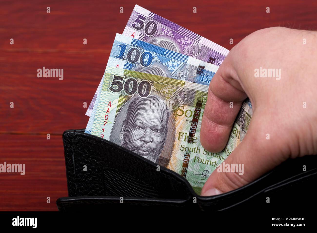 South Sudanese money - Pounds in a black wallet Stock Photo - Alamy