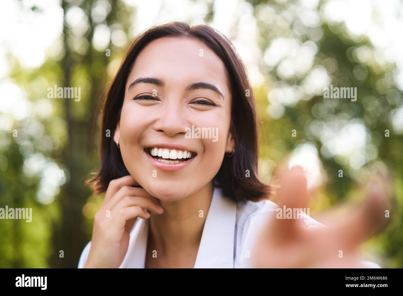 Genuine people. Portrait of asian woman laughing and smiling, walking ...