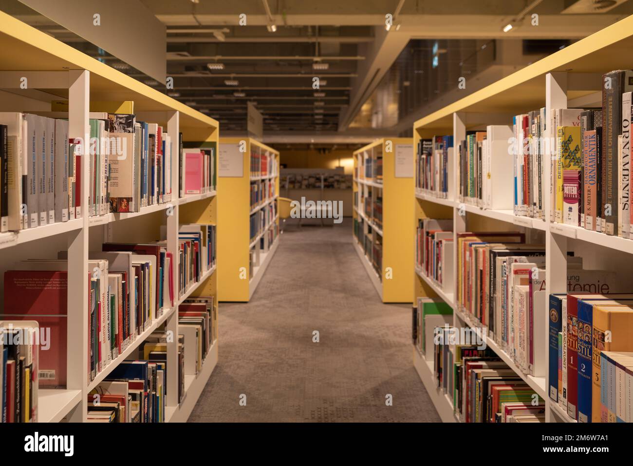 Selective focus and Interior view of corridor between row of bookshelf ...