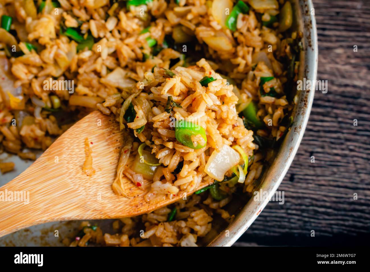 Kimchi Fried Rice Scooped on a Bamboo Spatula: Closeup of kimchi ...