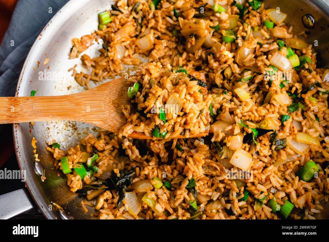 Kimchi Fried Rice Scooped on a Bamboo Spatula: Closeup of kimchi ...