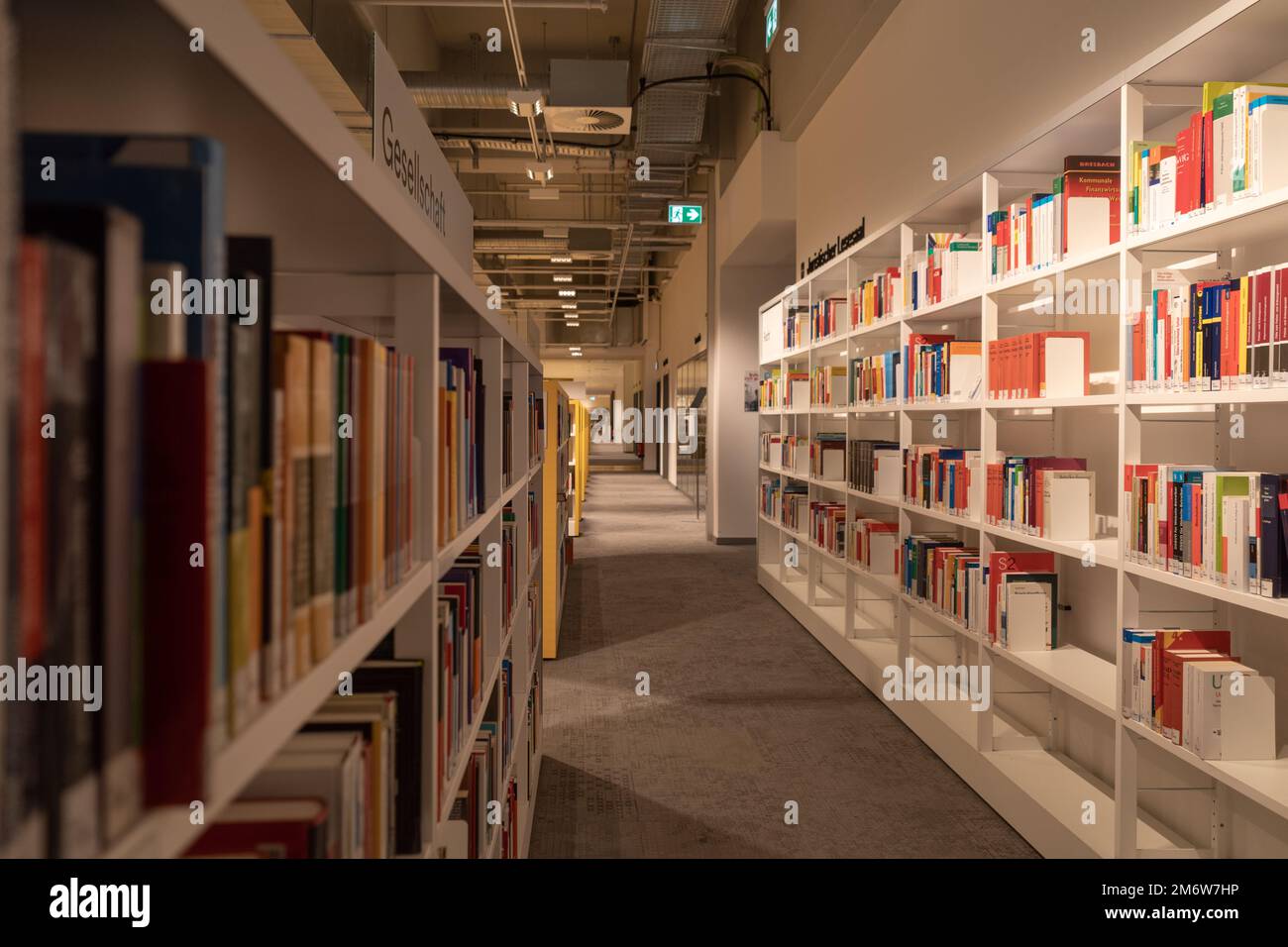 Selective focus and Interior view of corridor between row of bookshelf ...