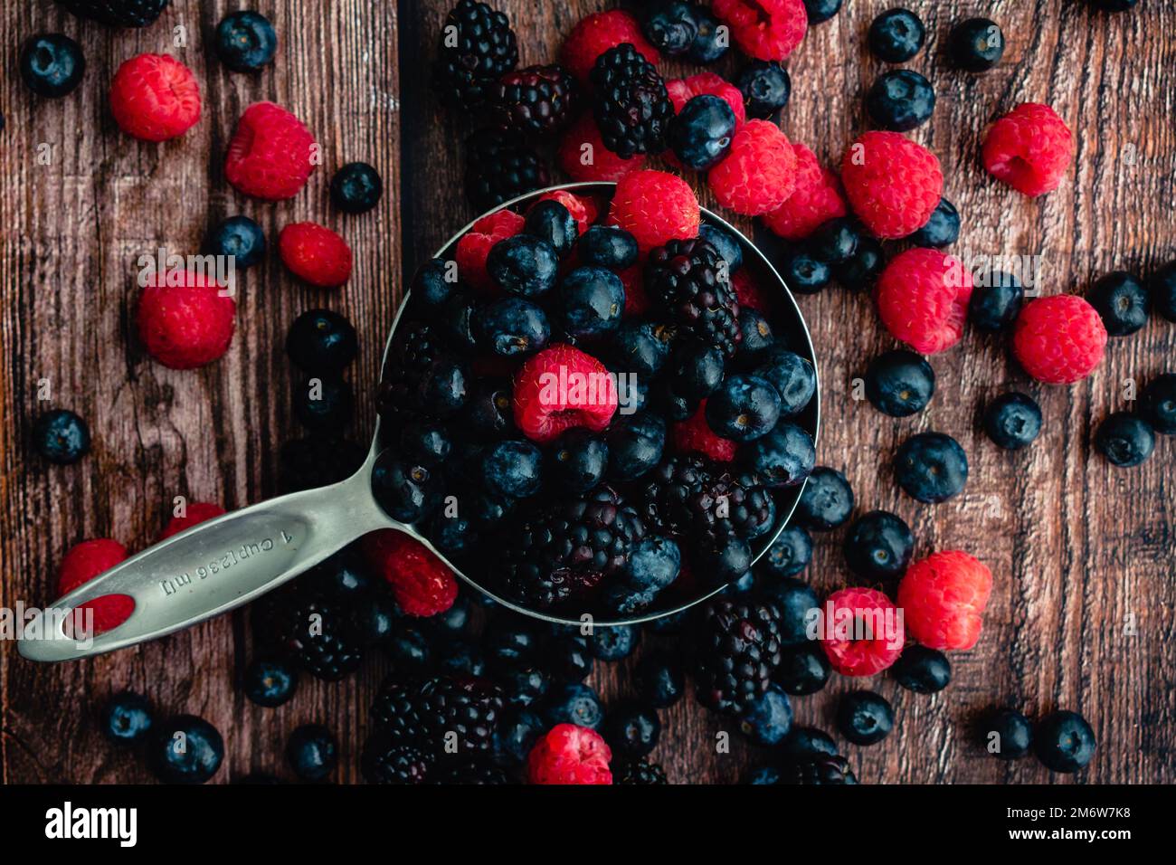 Blueberries, Raspberries, and Blackberries in a Measuring Cup: A ...