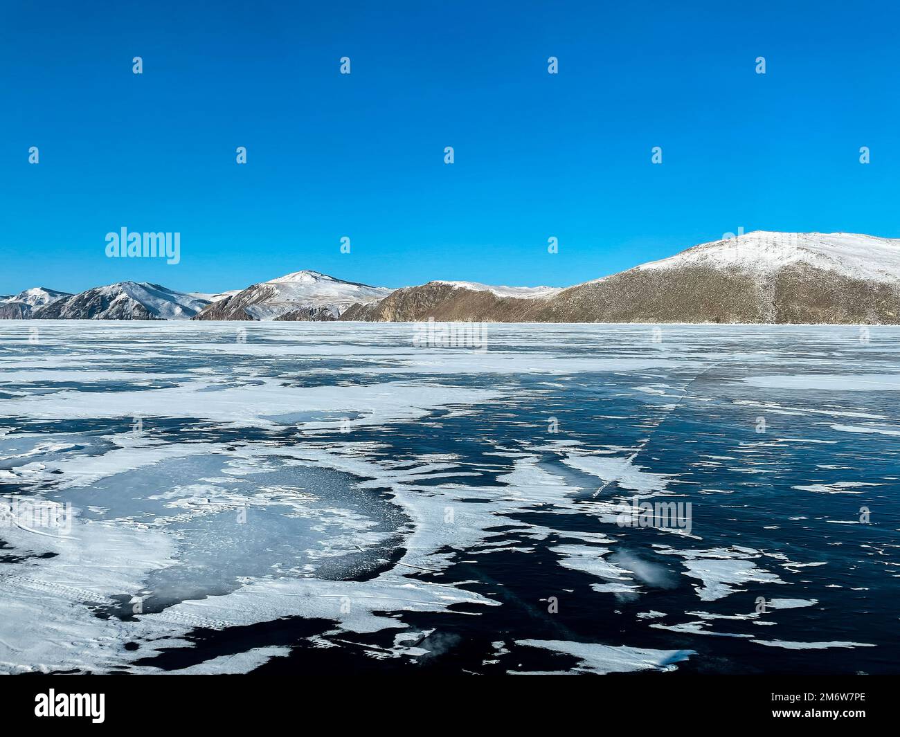 Texture of beautiful blue ice with cracks and air bubbles in the frozen ...