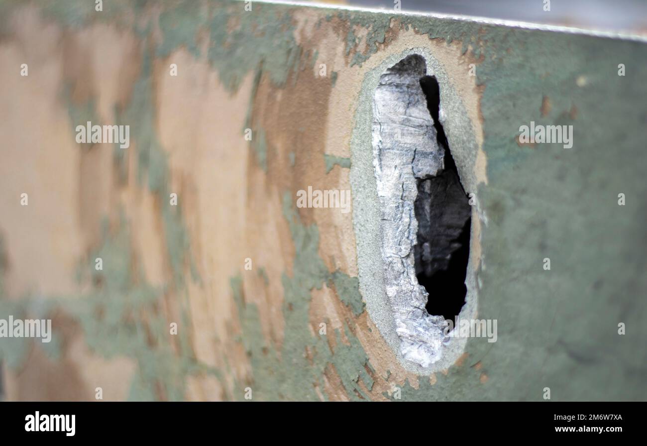 War in Ukraine, a hole in the armor of the BMP, pierced armor. Texture ...