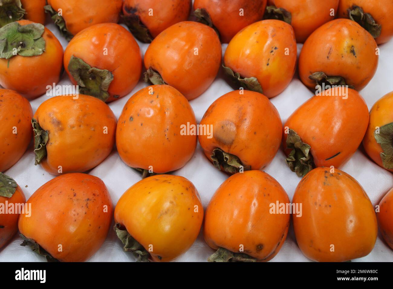 Fresh, ripe Korean red persimmons in gift set Stock Photo - Alamy
