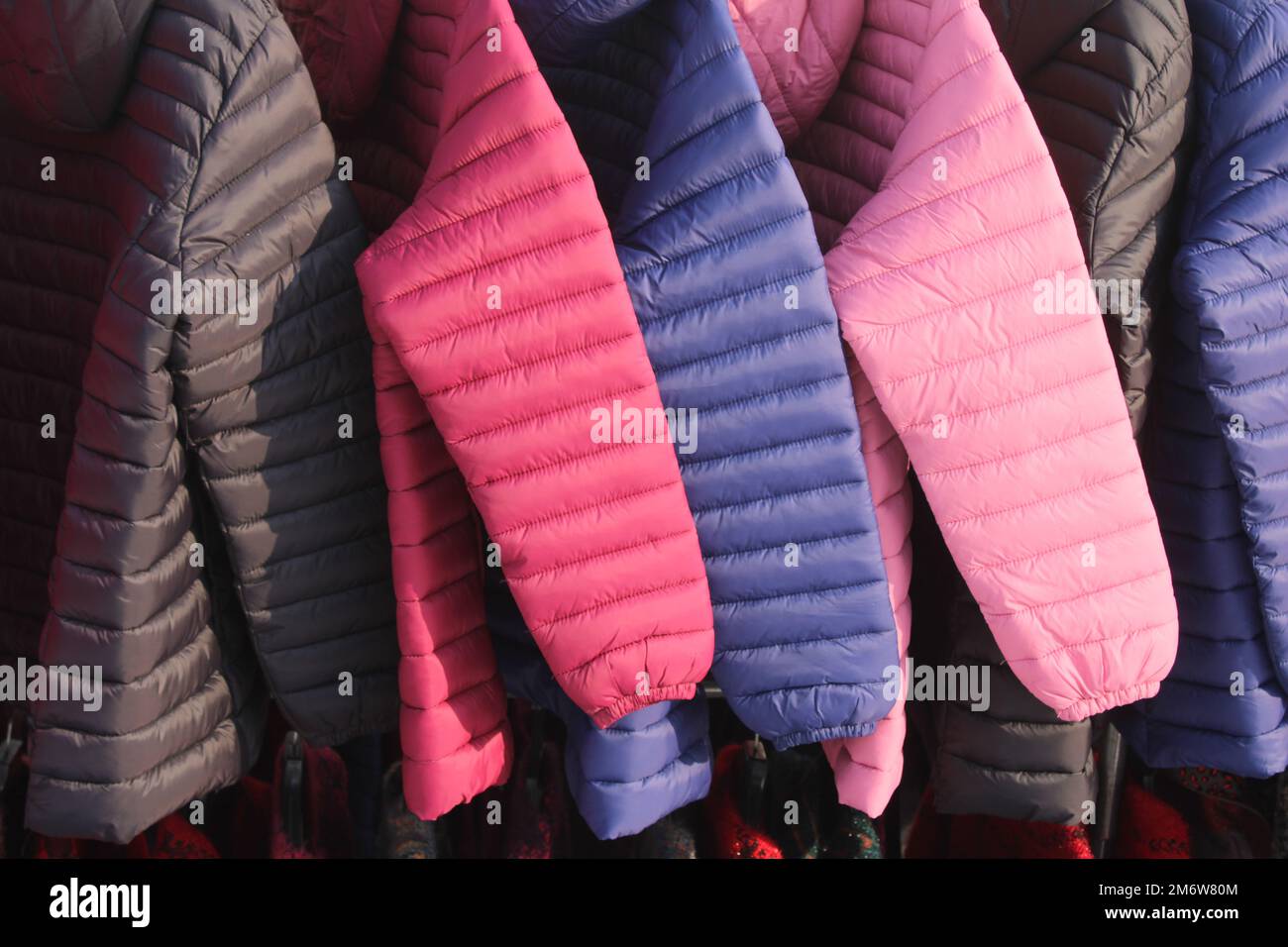 Winter jackets on outdoor clothing rack Stock Photo - Alamy