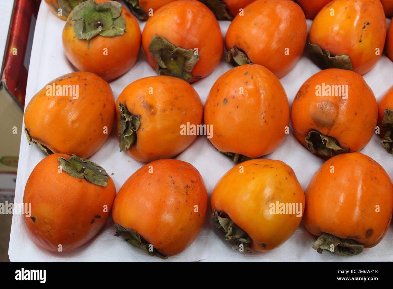 Fresh, ripe Korean red persimmons in gift set Stock Photo - Alamy
