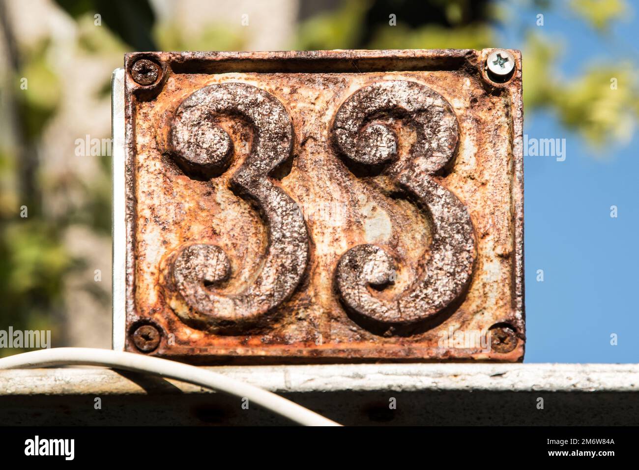 Old retro weathered cast iron plate with number 33 closeup Stock Photo ...