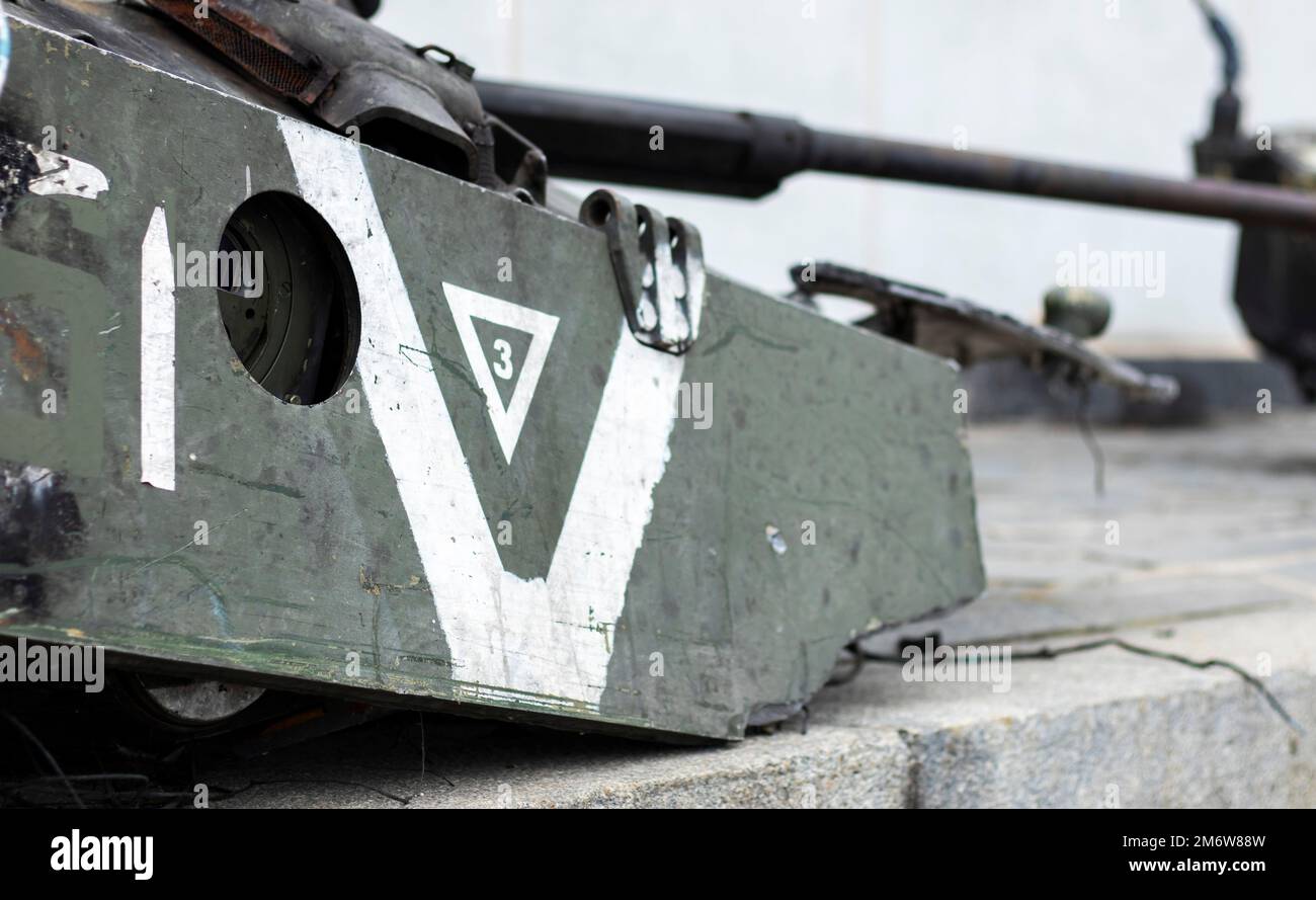 War in Ukraine. Destroyed tank with a torn off turret with a V on it ...