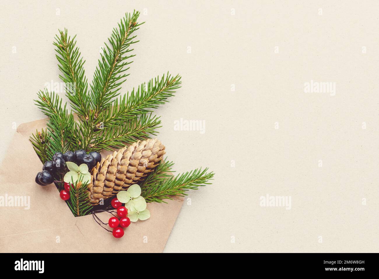 Christmas decoration, fir tree branch in envelope on kraft paper ...
