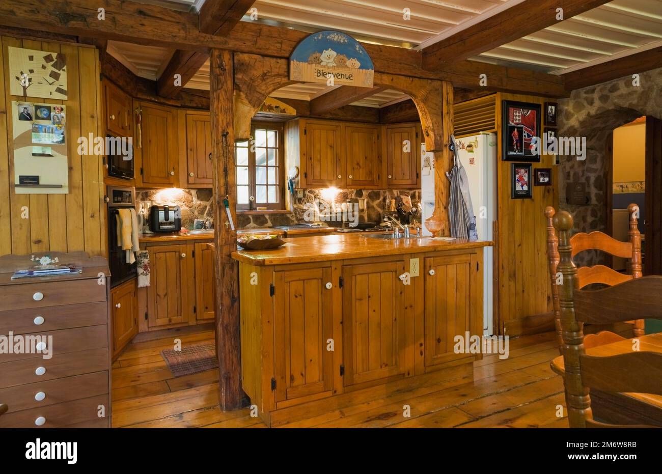 Country style kitchen with wood top island and dining room with wide ...