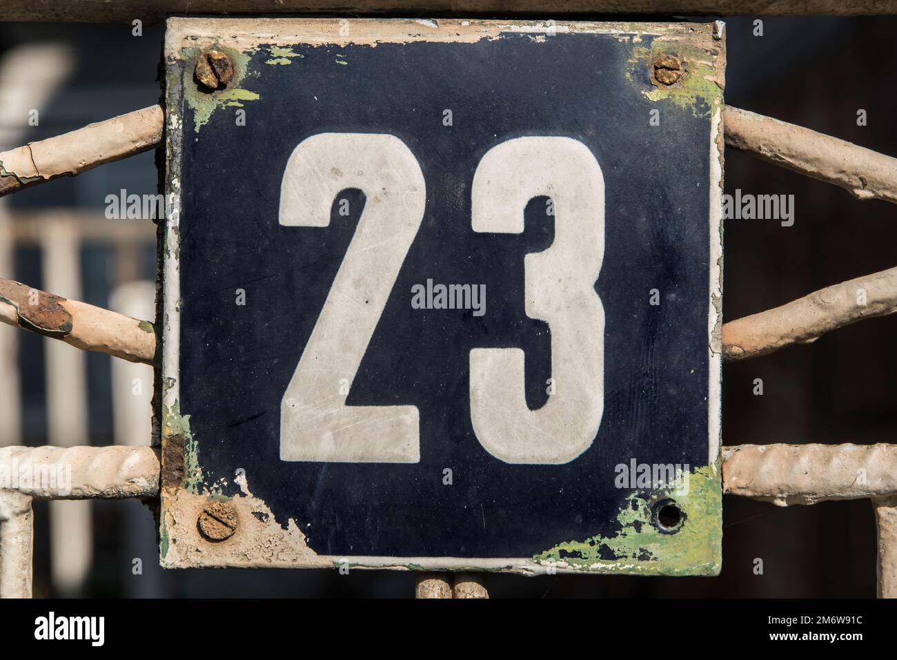Weathered grunge square metal enameled plate of number of street ...
