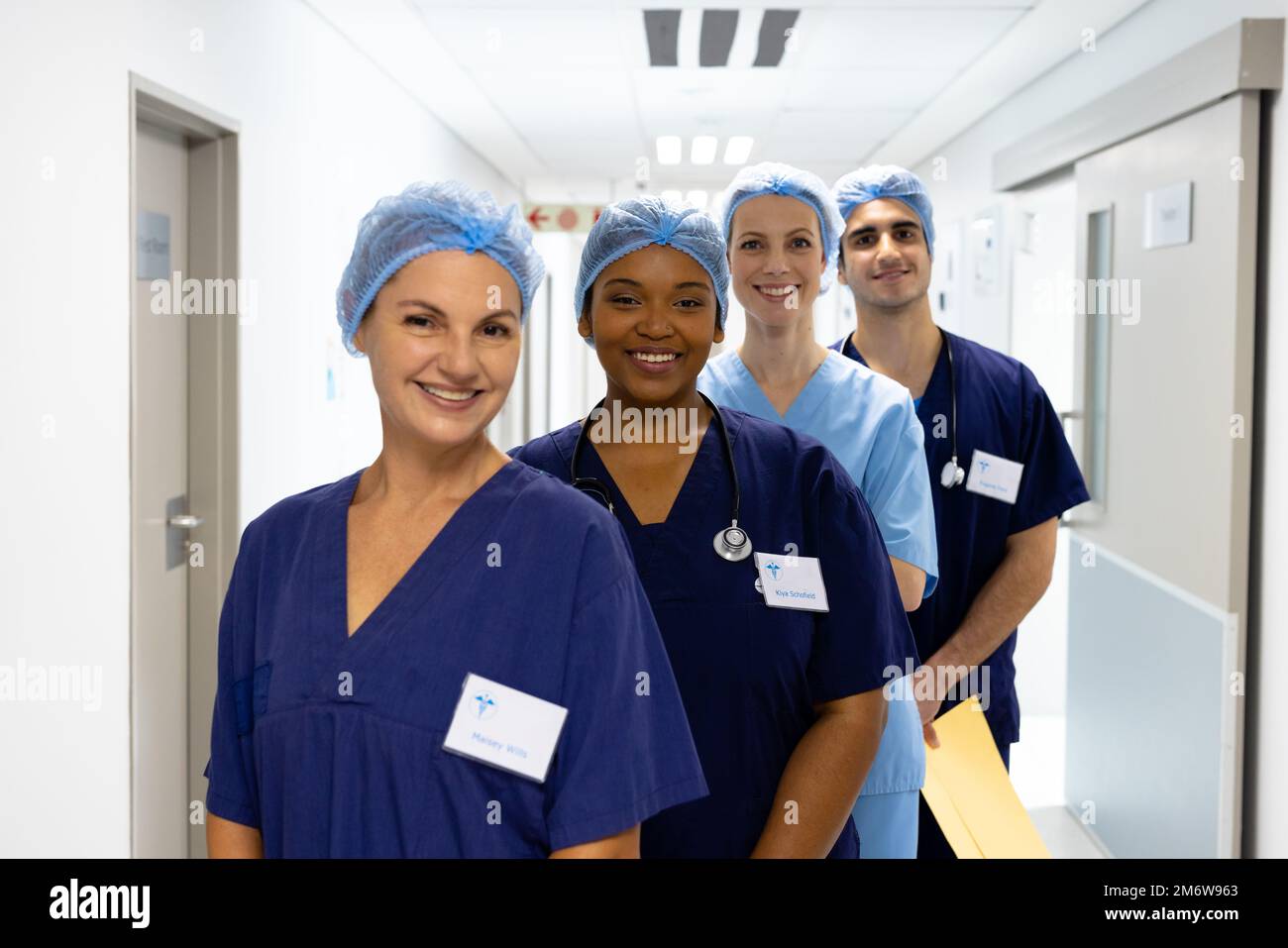 Portrait of diverse group of healthcare workers wearing surgical caps ...