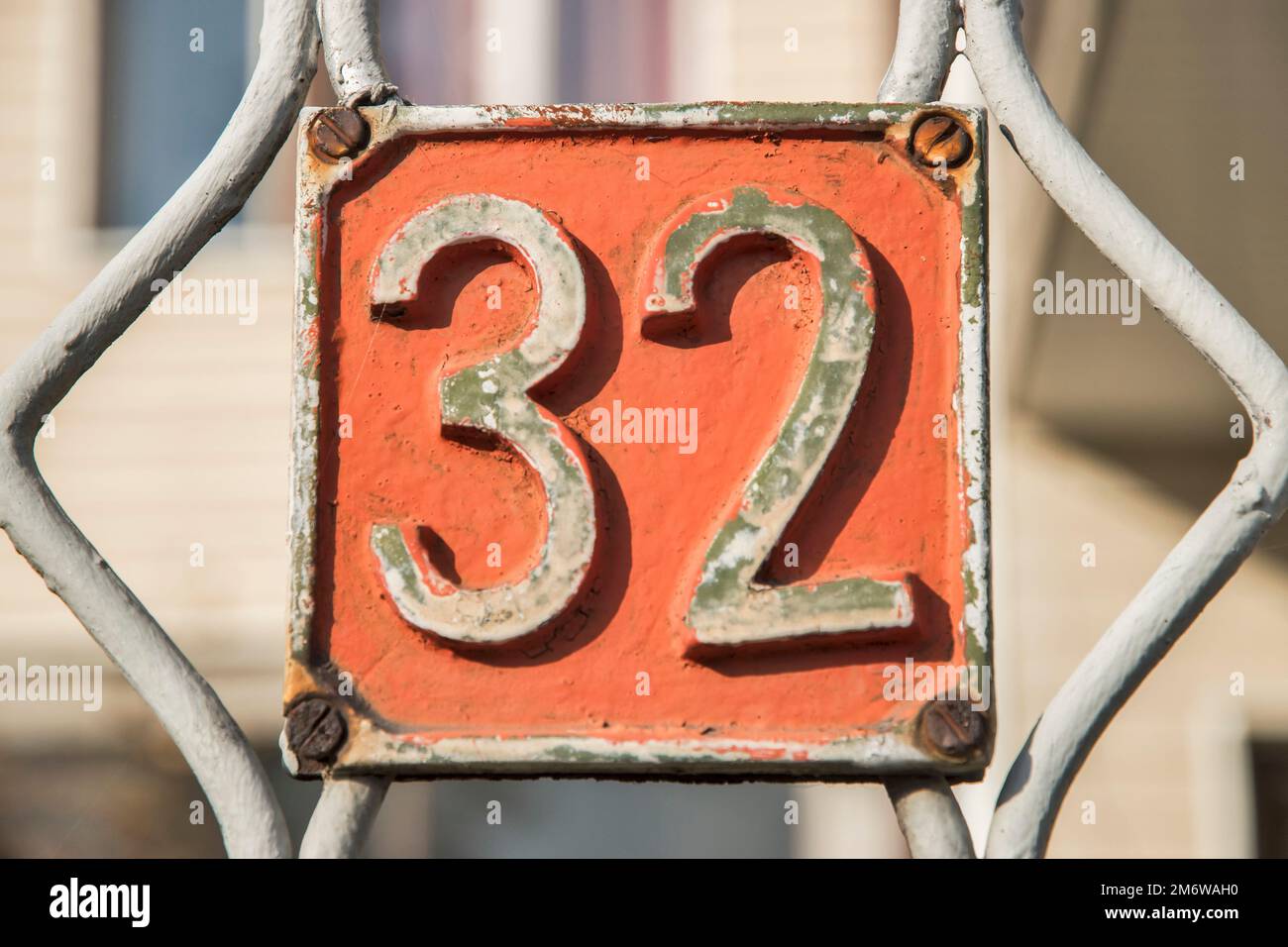 Old retro weathered cast iron plate number 32 closeup Stock Photo - Alamy