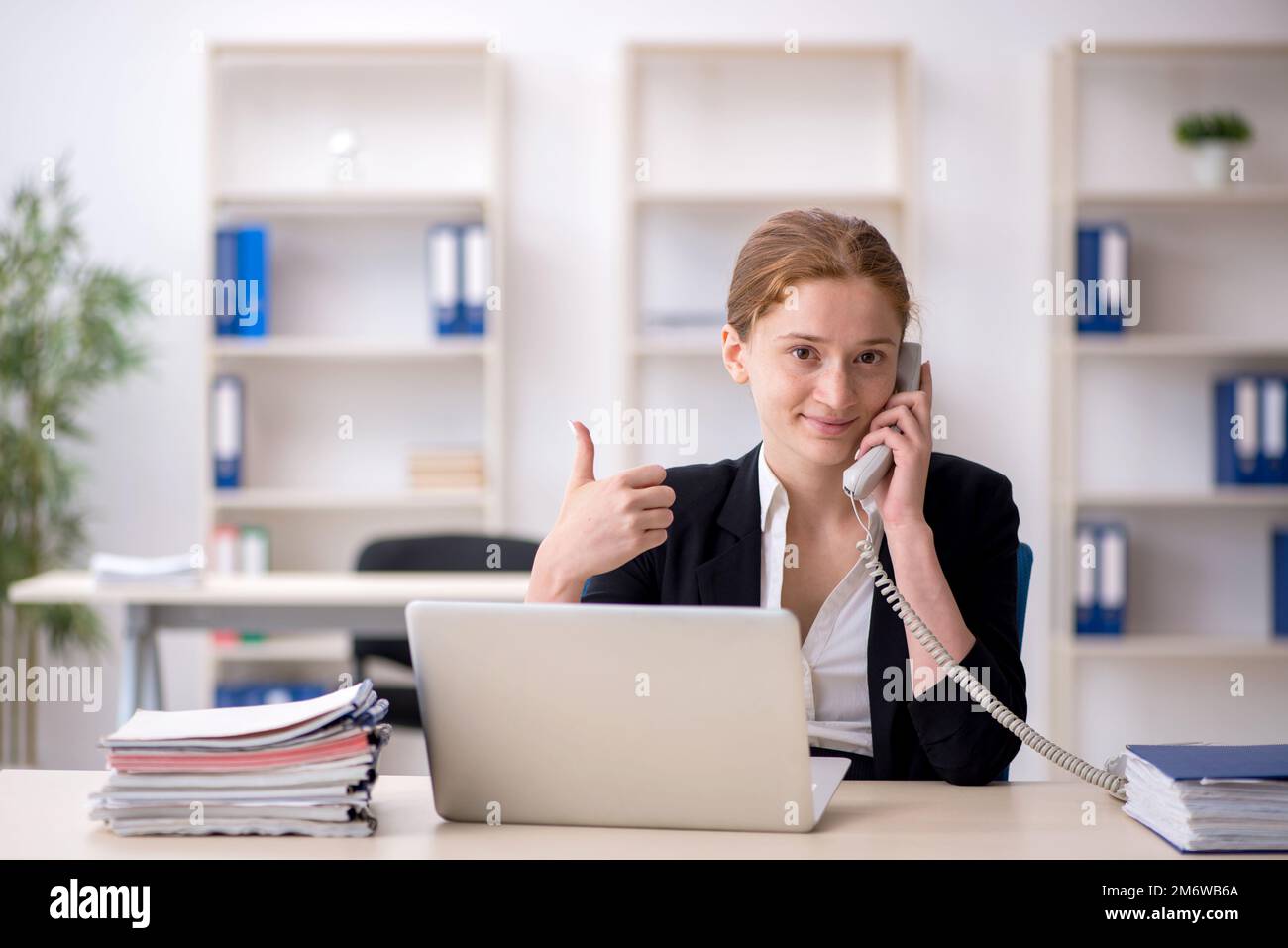 Young female employee working in the office Stock Photo - Alamy
