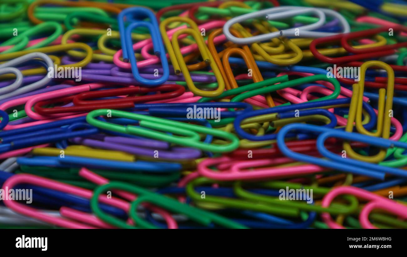 Colorful paper clips isolated on black background Stock Photo - Alamy