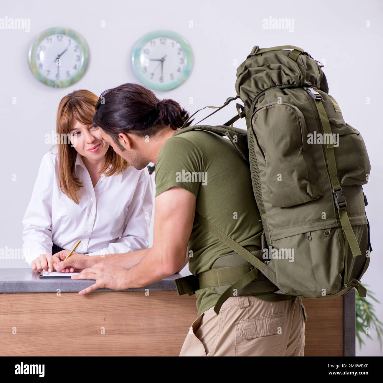 Reception man and woman writing hi-res stock photography and images - Alamy