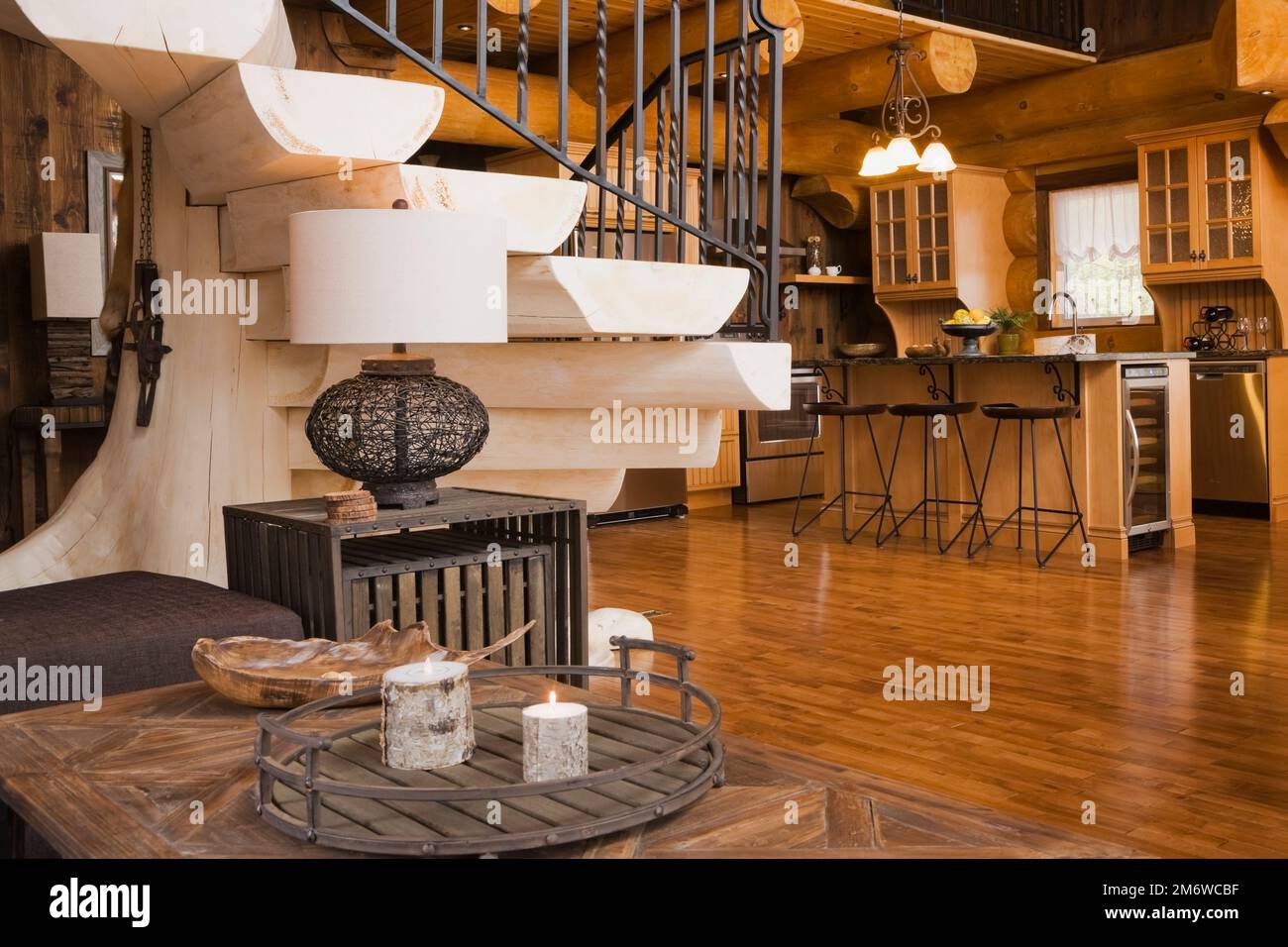 Table and bleached wooden stairs with black wrought iron railing in ...