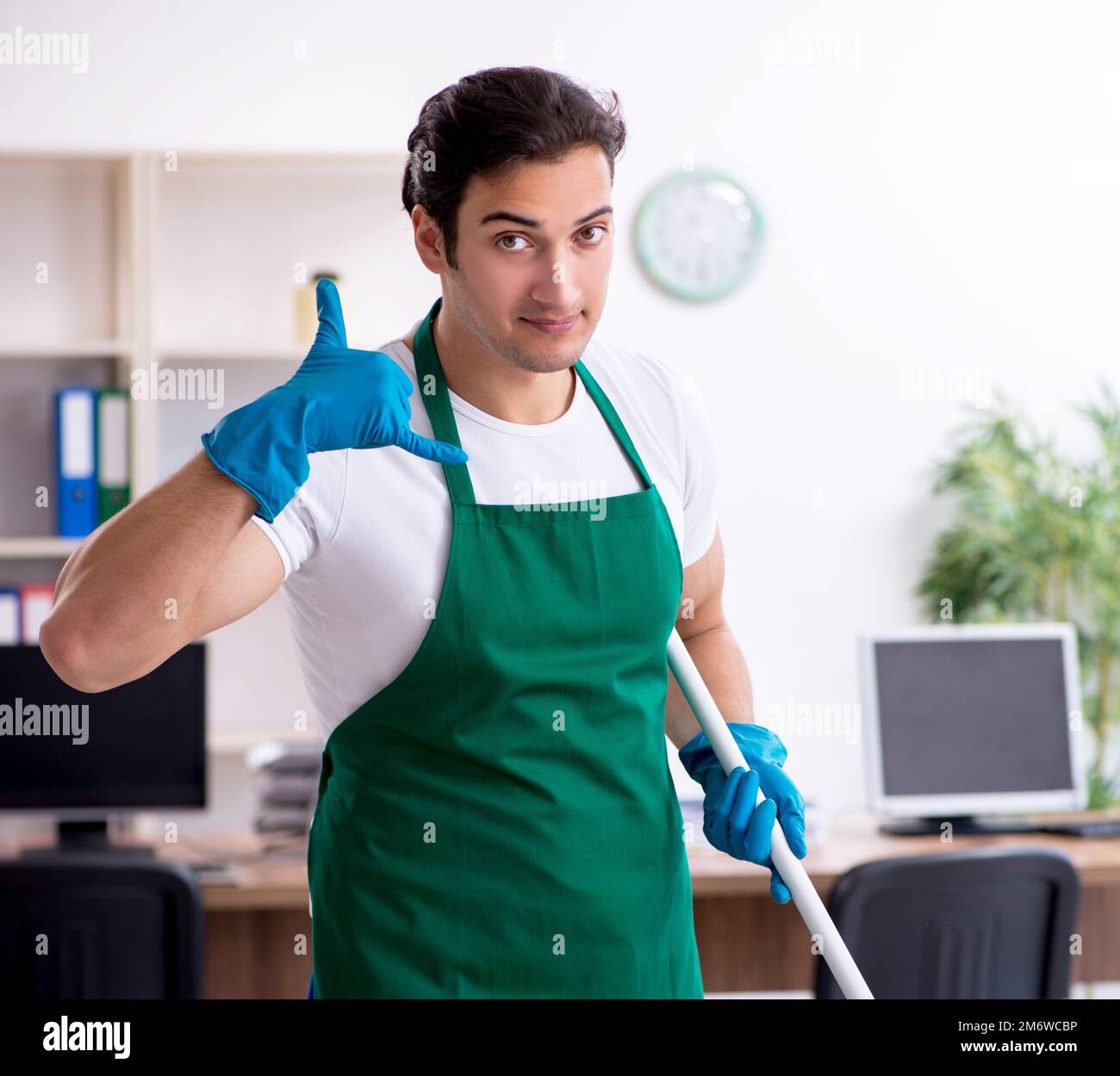 Man sweeping floor dustpan broom hi-res stock photography and images ...