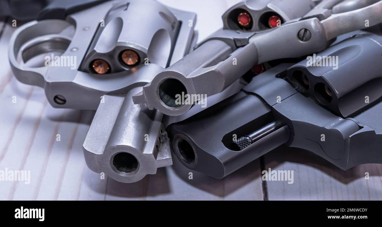 Three snub nose revolvers, a black 38 special, a stainless steel 357 ...