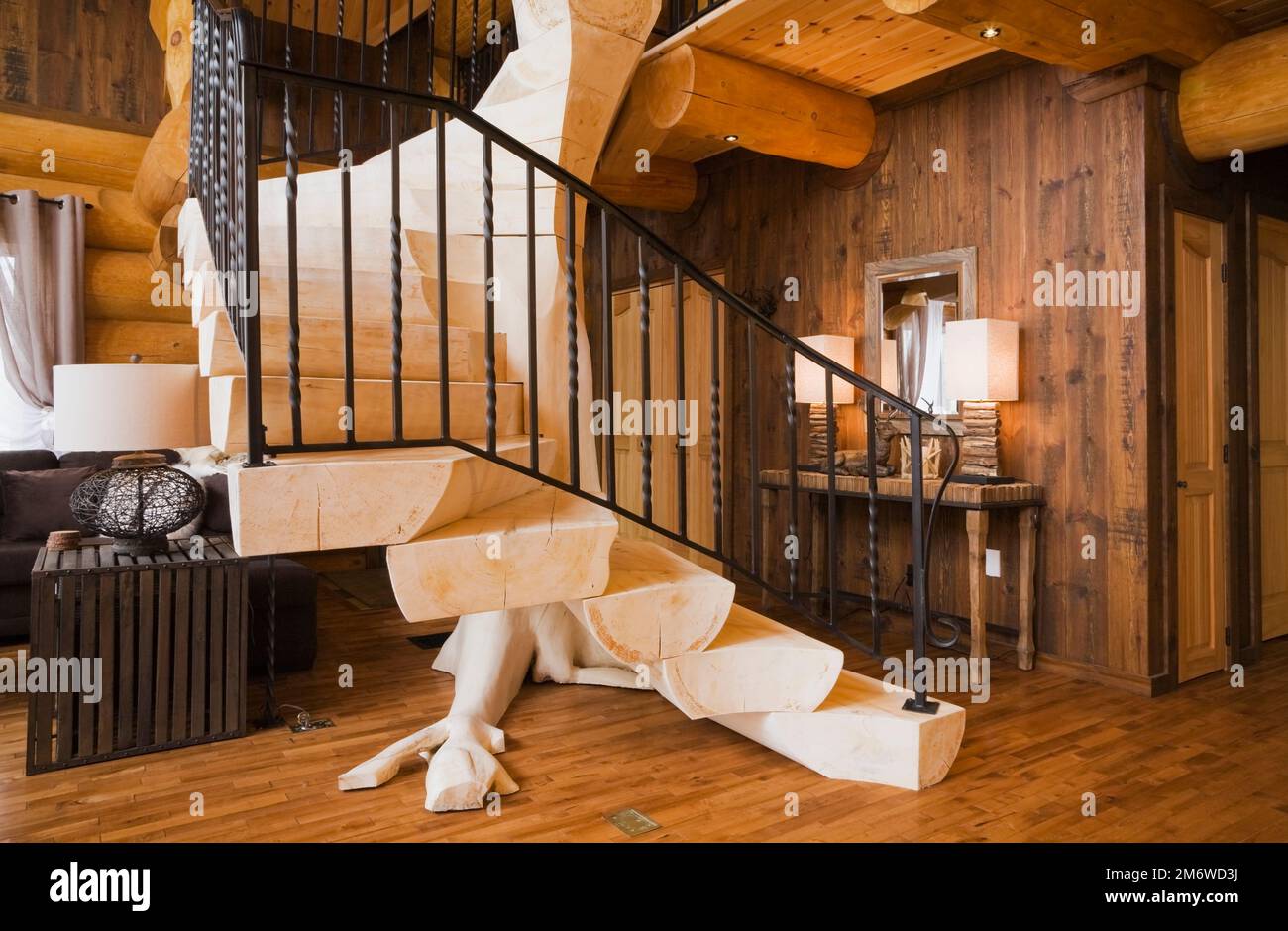 Bleached wooden stairs with black wrought iron railing in living room ...