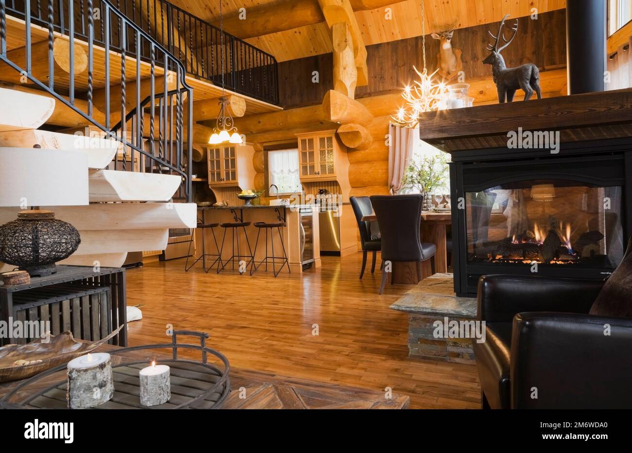 Bleached wooden stairs with black wrought iron railing, fireplace in ...