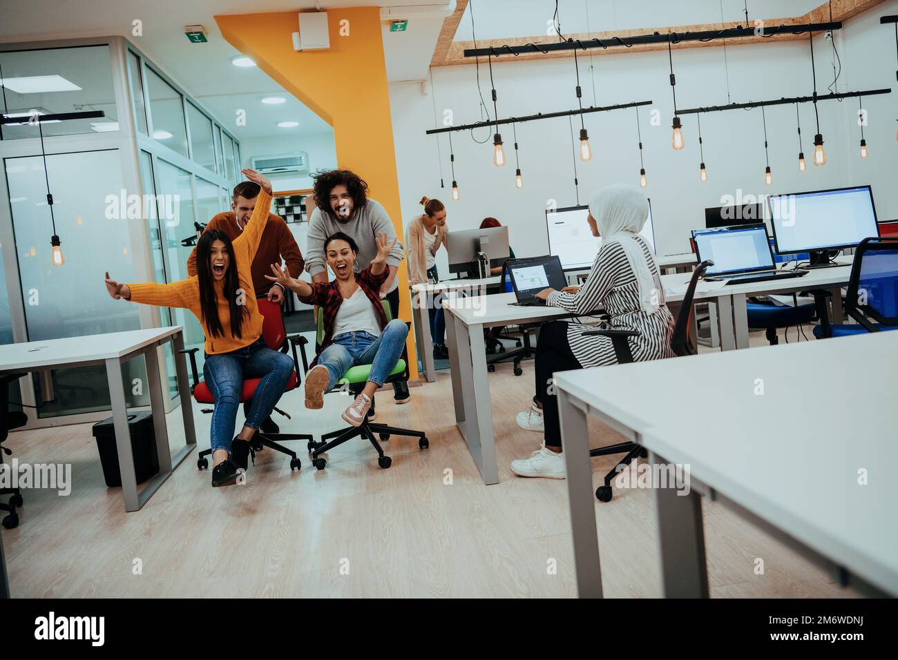 Team building and office fun. Young cheerful businesspeople in smart ...