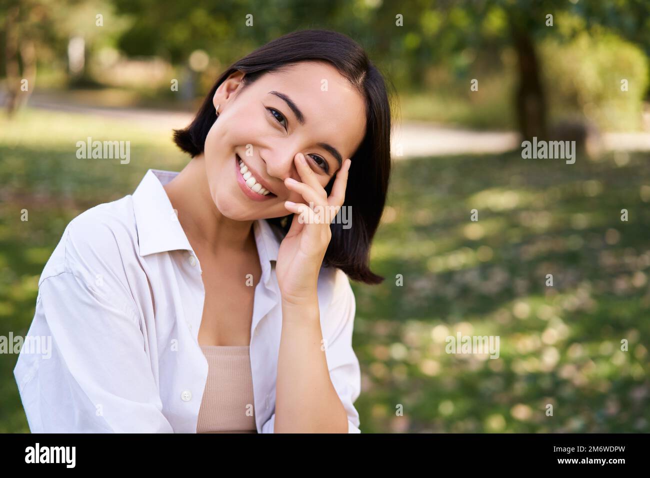 Beautiful young asian girl smiling, laughing and walking along park ...