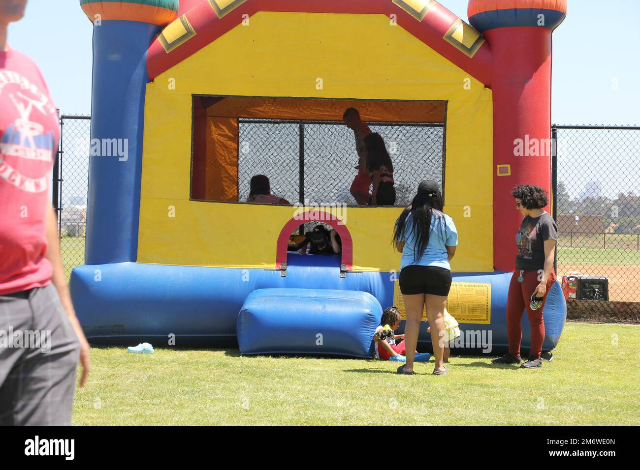 Kids rush to bounce in the bounce house Stock Photo - Alamy