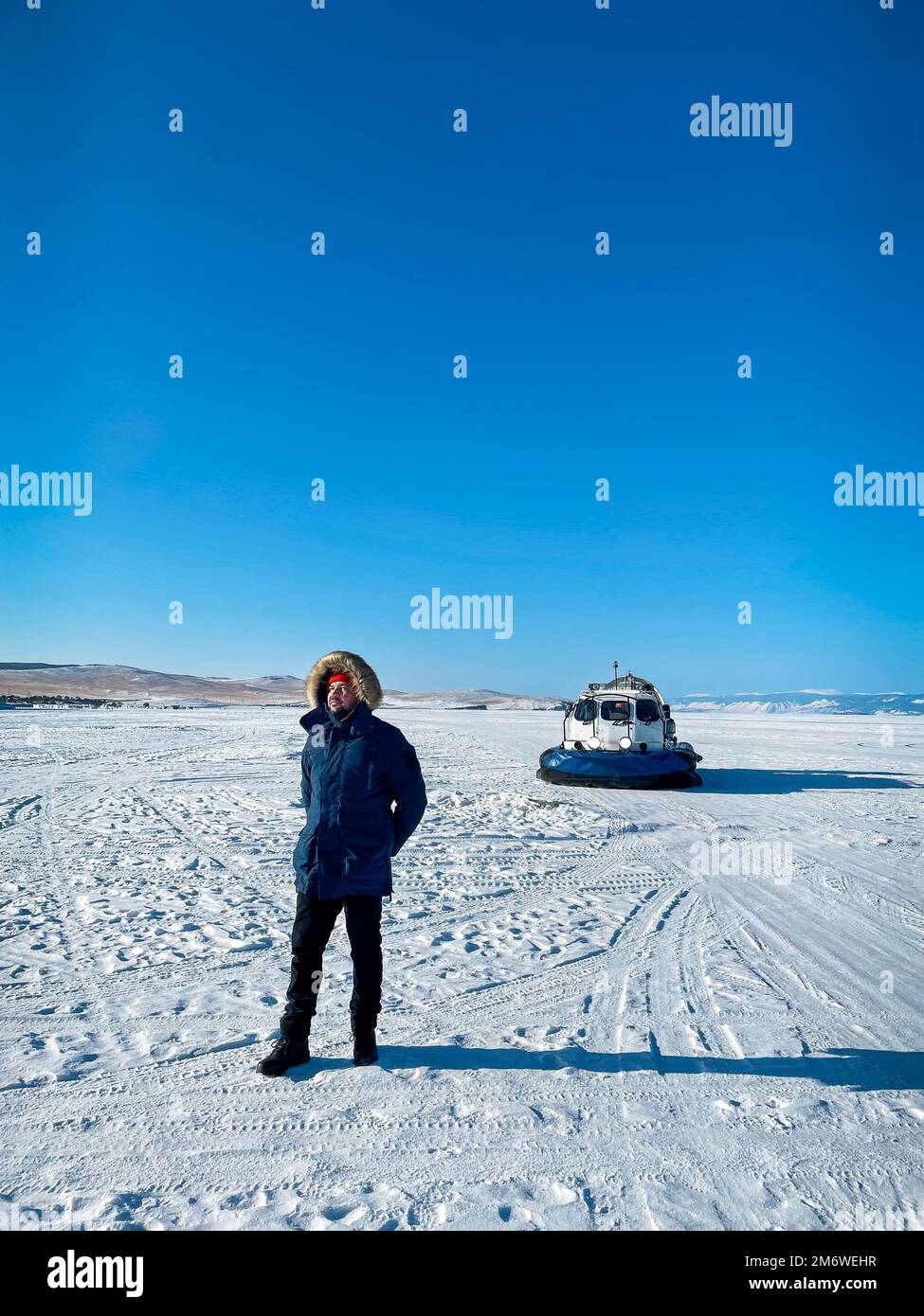 Portrait of the man wearing winter clothes standing by Khivus ...