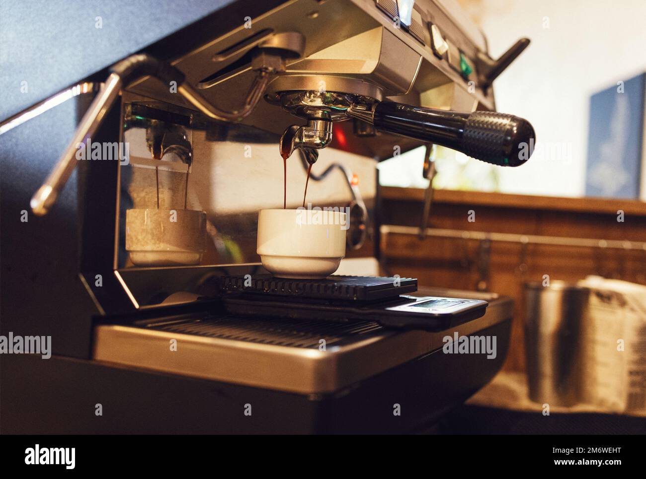 Close up of espresso pouring from coffee machine Stock Photo - Alamy