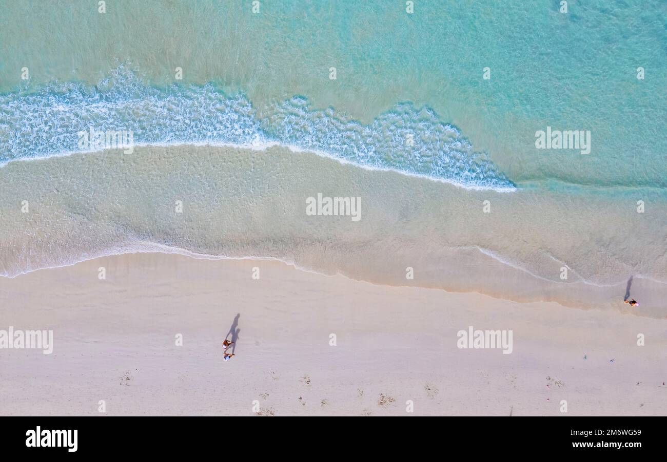 Drone view from above at ocean and beach with chairs and umbrellas ...