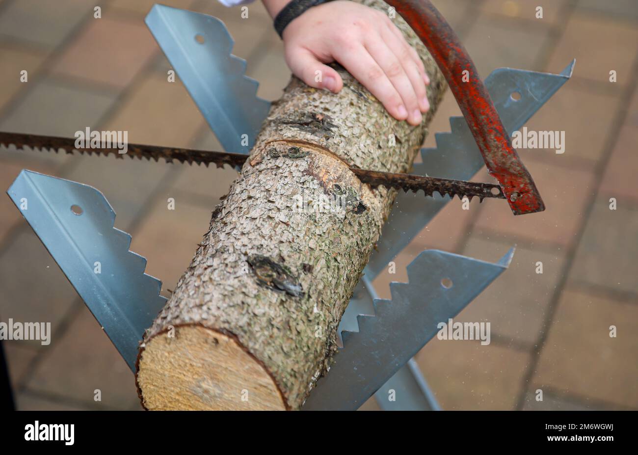 Details of a sawhorse with log and saw at a wedding Stock Photo - Alamy